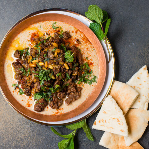 Lebanese Hushwee with Spices and Toasted Pine Nuts Over Tahini